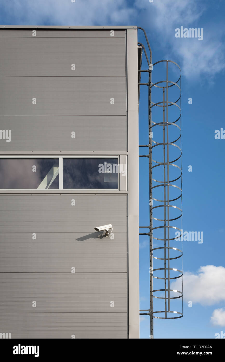 A metal ladder leading up to the roof of an industrial building Stock ...