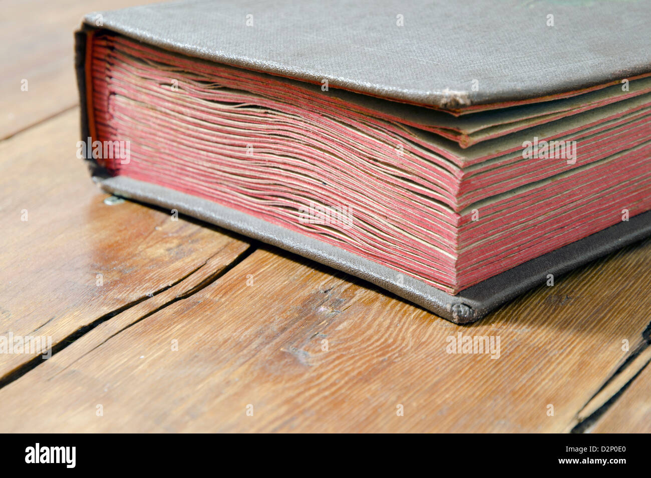 fragment of old book laying on the weathered wooden surface Stock Photo ...