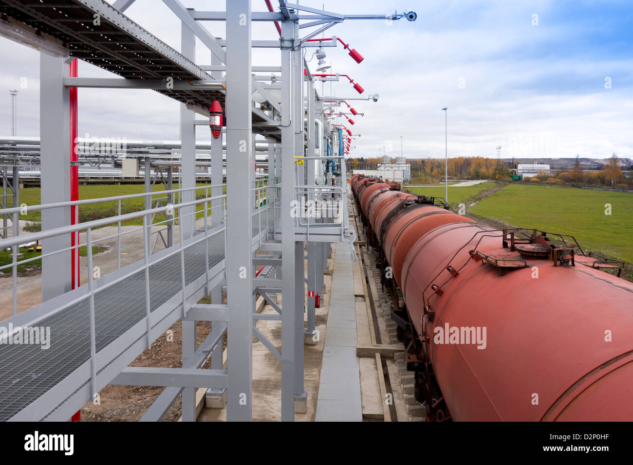 A shale oil storage facility, with storage tanks and railway wagons to ...