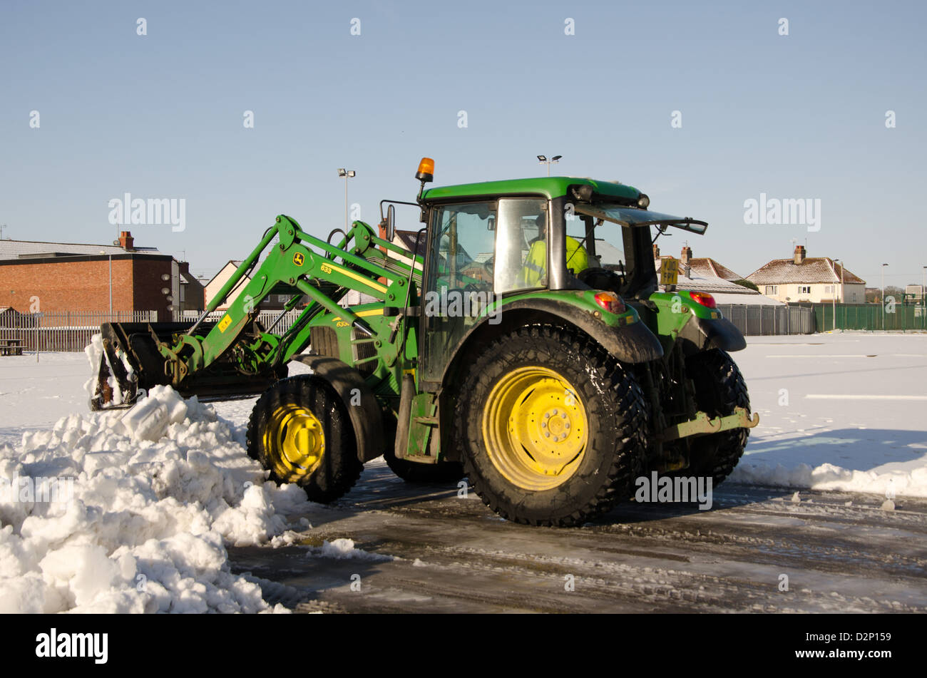 Tractor clearing the snow from a car park in Bridlington Stock Photo ...