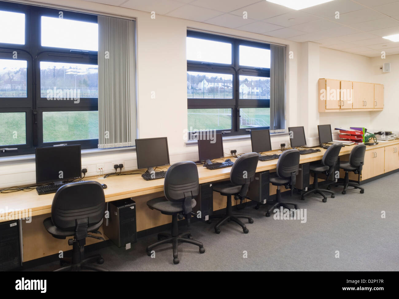 Row of computers and chairs in a classroom of a modern secondary school ...