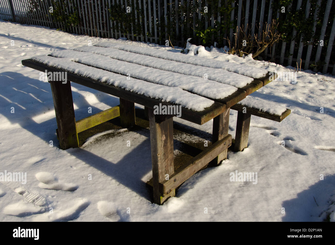 Picnic table covered in Snow Stock Photo - Alamy