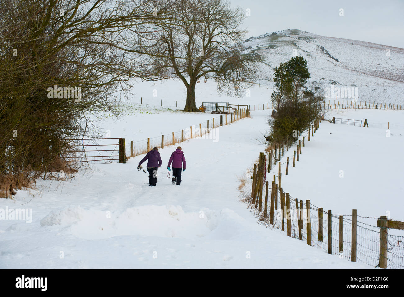 Two walkers heading towards Gaerstone in Winter Snow, Church Stretton ...