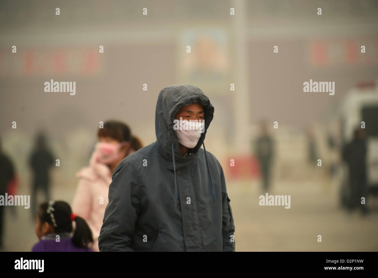 A man wears a mask on Tiananmen Square in thick haze in Beijing, China ...