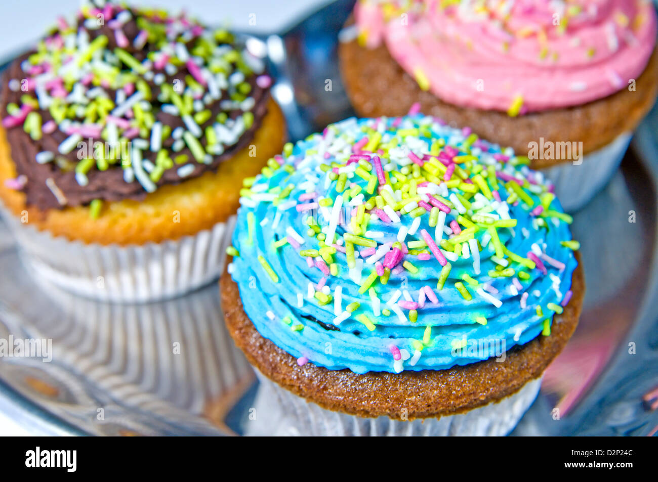 muffins with colored cream Stock Photo - Alamy