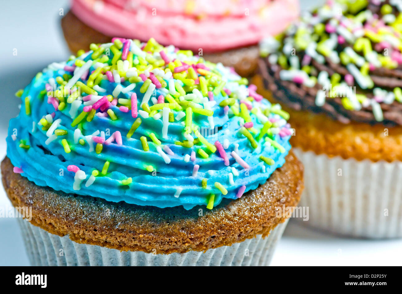 muffins with colored cream Stock Photo - Alamy