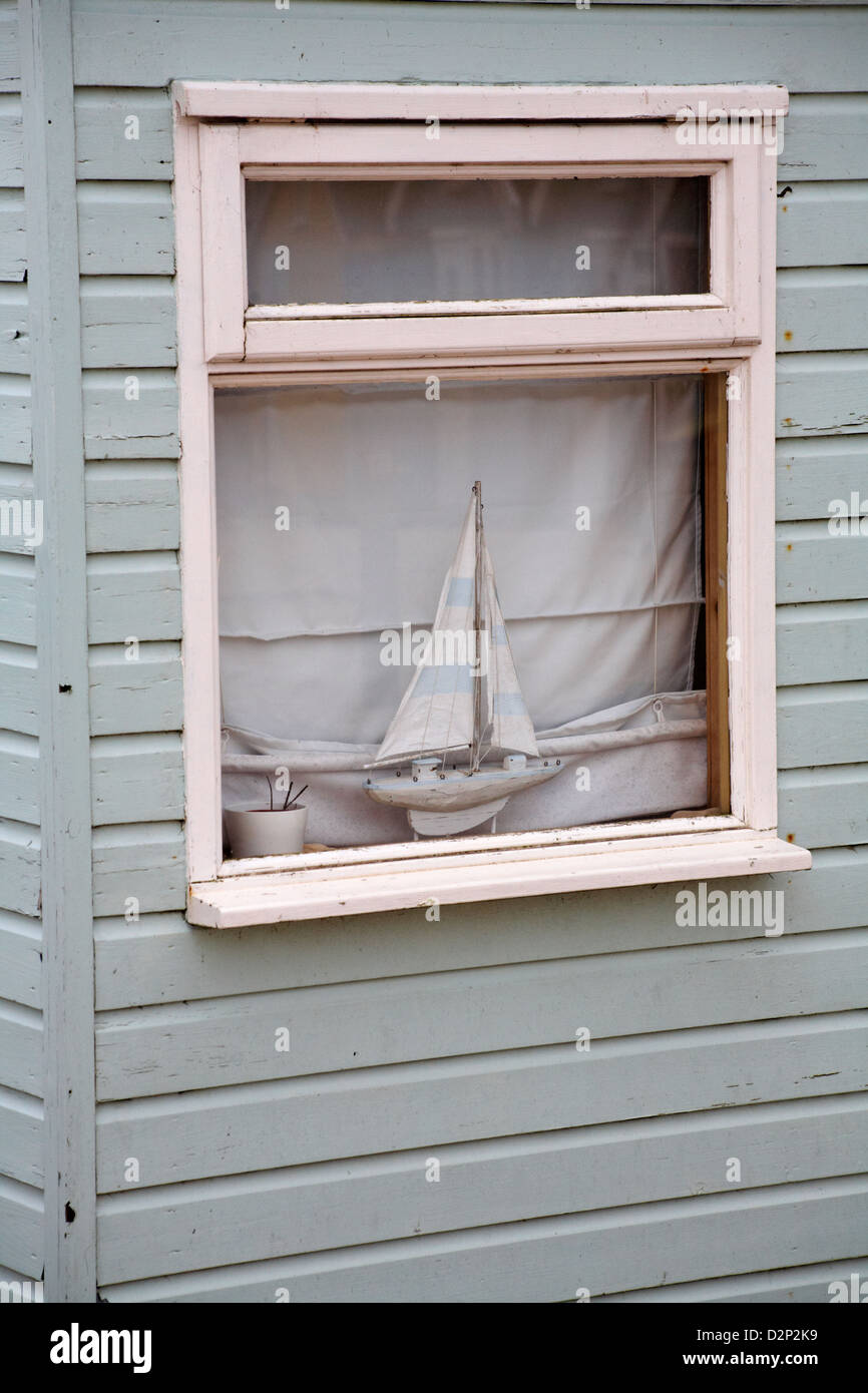 Model yacht in beach hut window at Hengistbury Head, Dorset in January ...