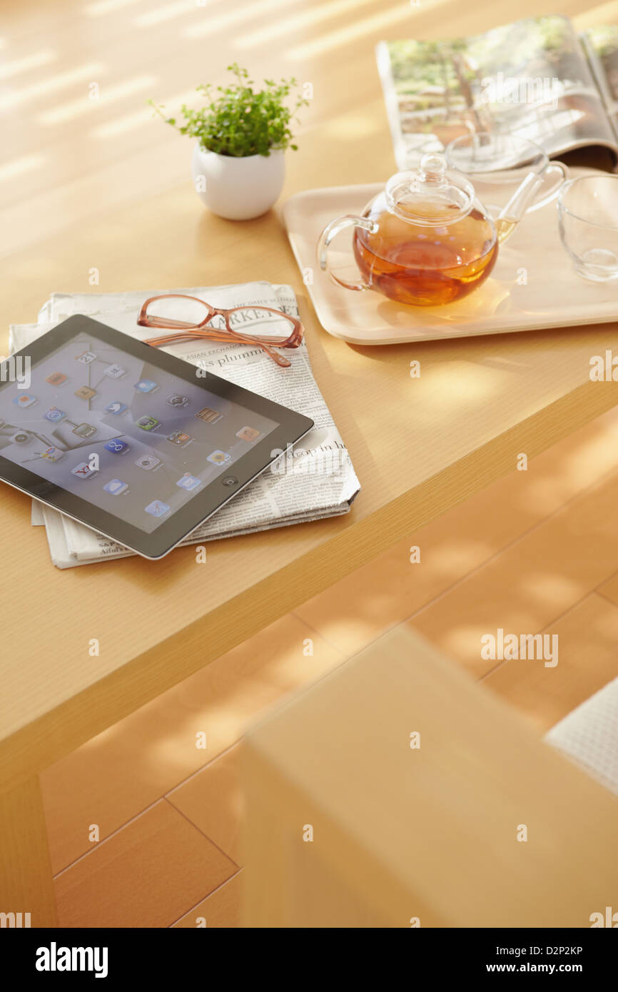 Tea tablet and newspapers on a table Stock Photo - Alamy