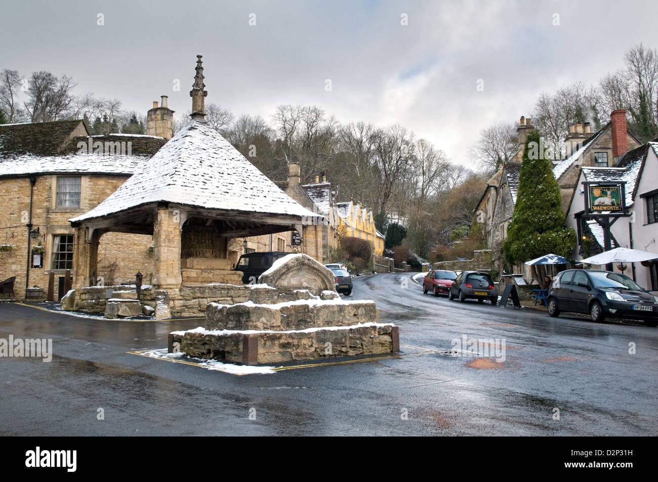 Winter snow scene of the market cross, Castle Combe, Cotswolds, England ...