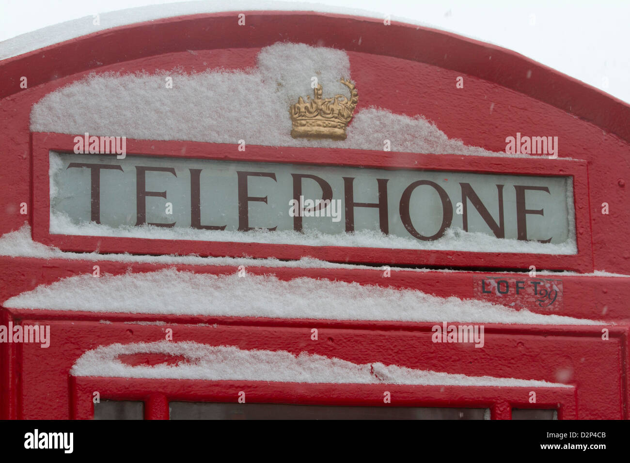 A red Telephone box covered in snow Stock Photo - Alamy