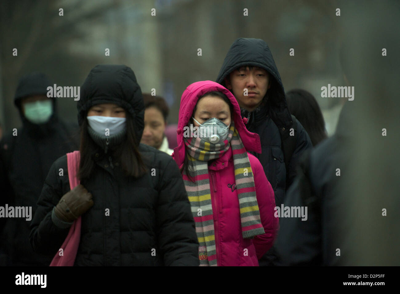 Pedestrians wear the masks in thick haze in Beijing, China. 30-Jan-2013 ...