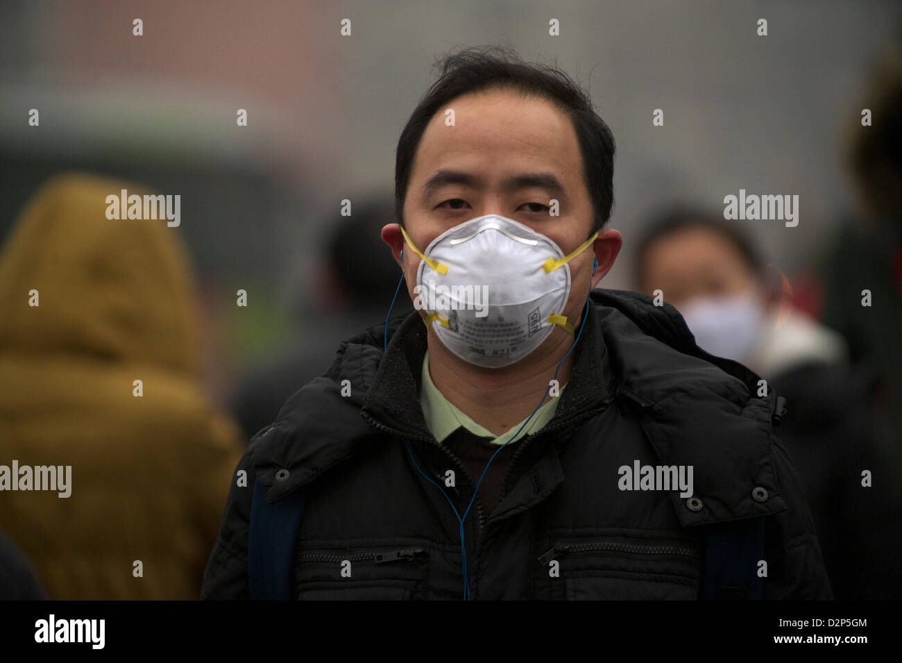 A man wears a mask in thick haze in Beijing, China. 30-Jan-2013 Stock ...