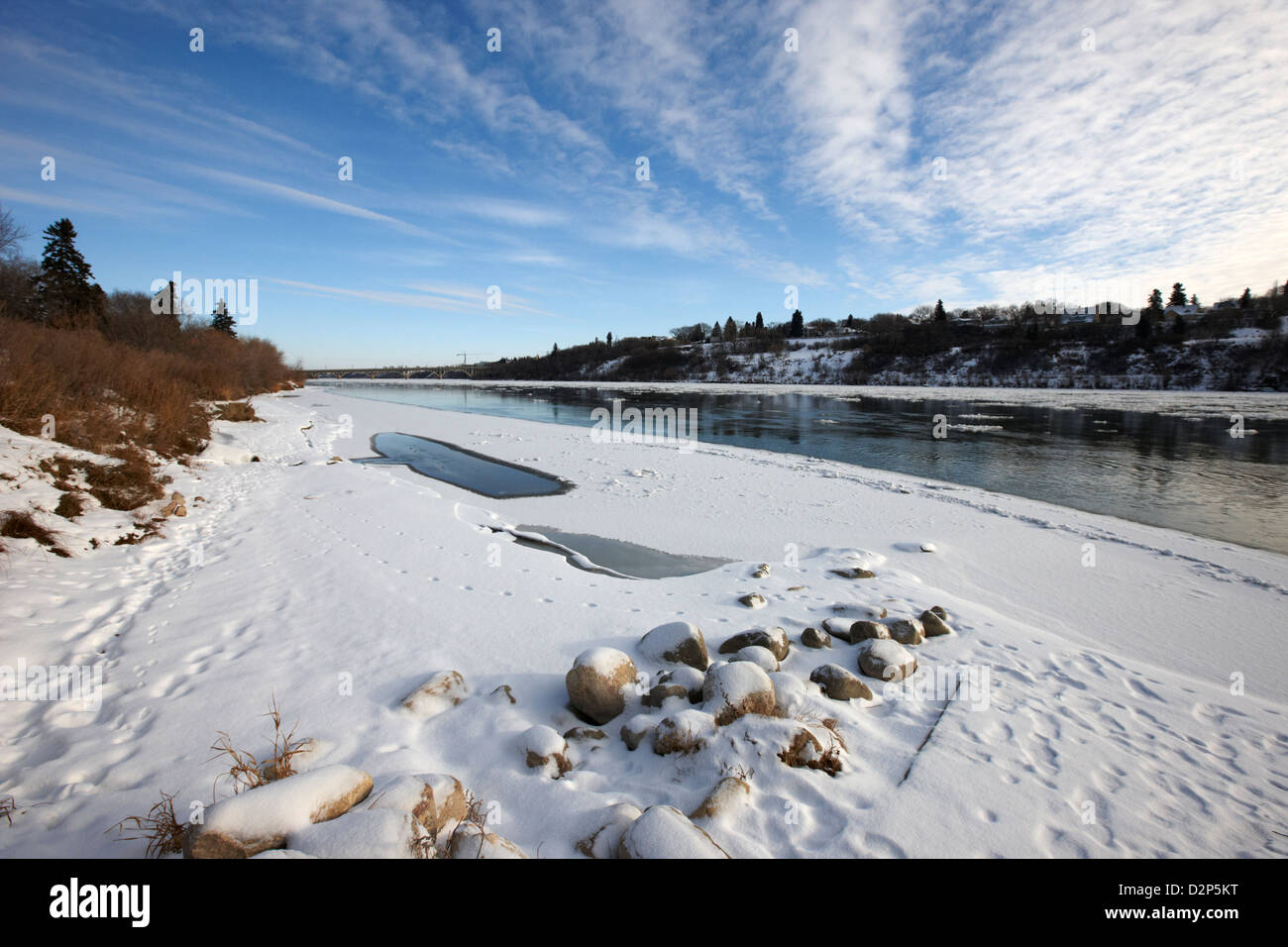 frozen river bank of the south saskatchewan river in winter flowing ...