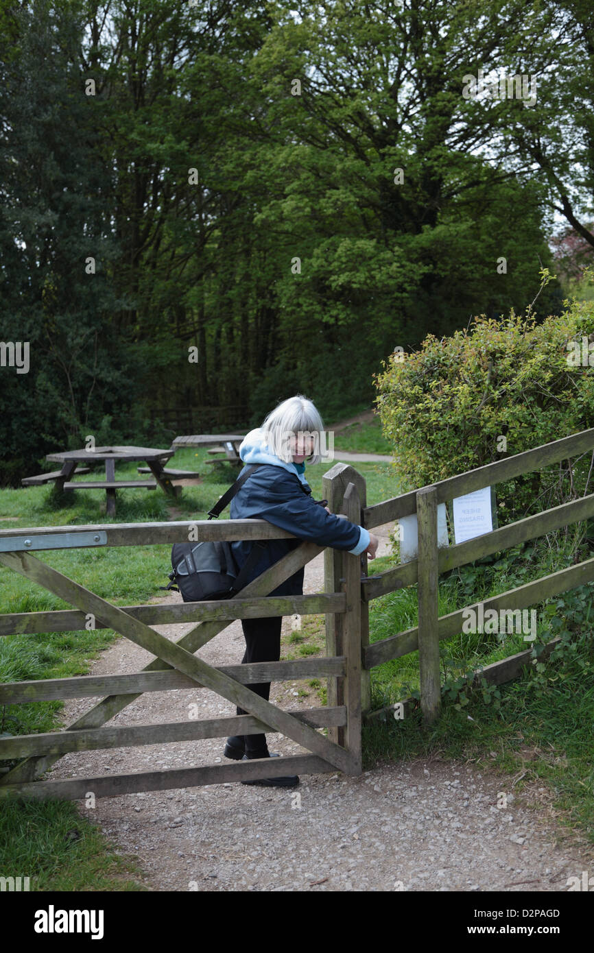 Woman walking through gate Stock Photo - Alamy