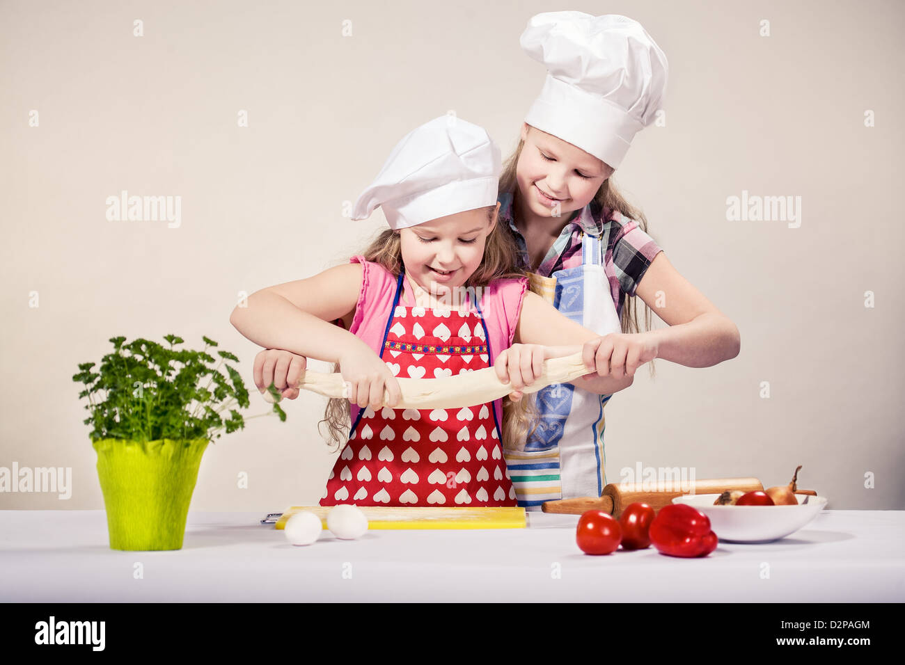 young girls baking cakes in the kitchen Stock Photo - Alamy