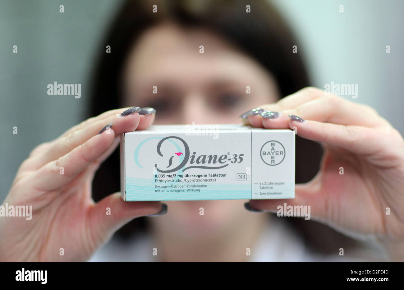 A pharmaceutical assistant holds a pack of the contraceptive Diane 35 ...