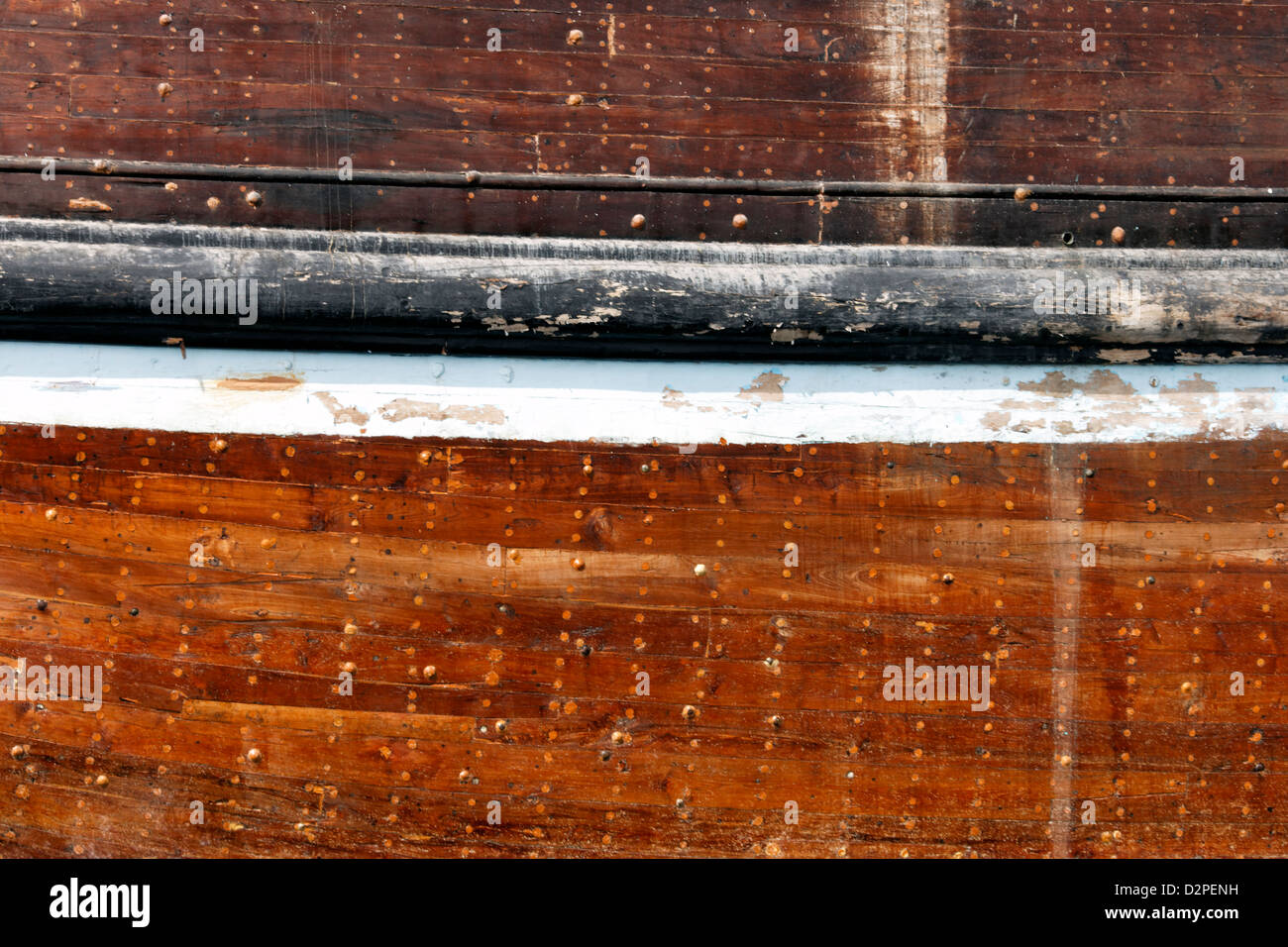 The wooden hull of a traditional dhow moored on Dubai Creek (detail ...