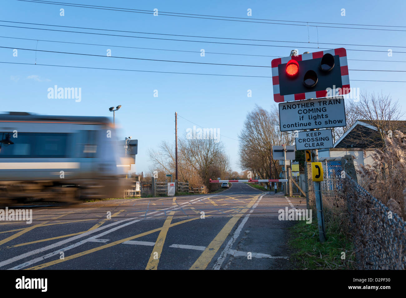A railway level crossing in a rural area at Waterbeach Cambridge with ...