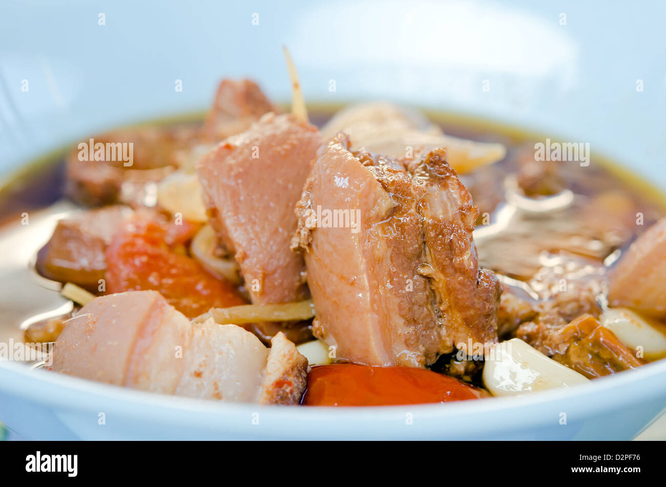 close up stewed pork knuckle with tomato and vegetable Stock Photo - Alamy