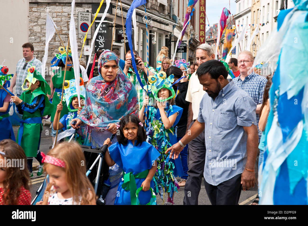A small carnival parade through a street Stock Photo - Alamy