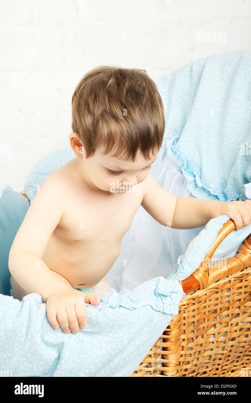 funny boy in cradle, happy and smiling Stock Photo - Alamy