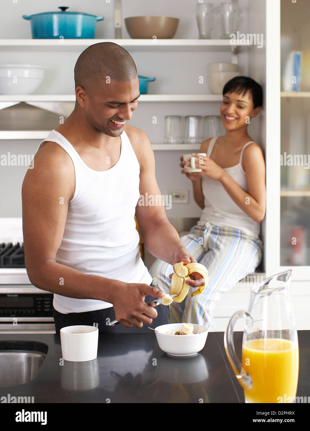 Couple eating breakfast in kitchen Stock Photo - Alamy