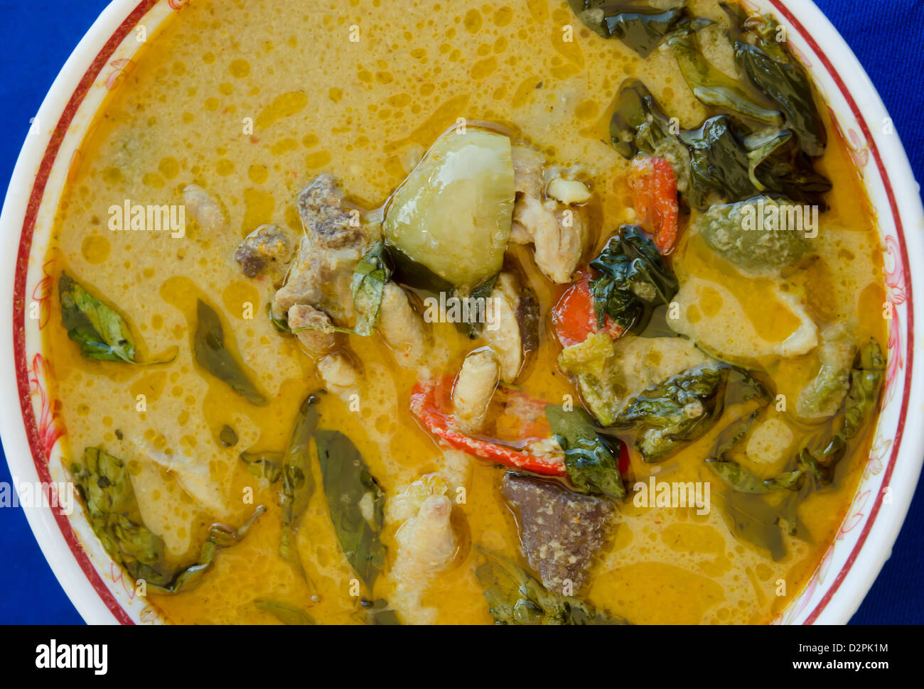 top view green chicken curry in bowl on blue background Stock Photo - Alamy