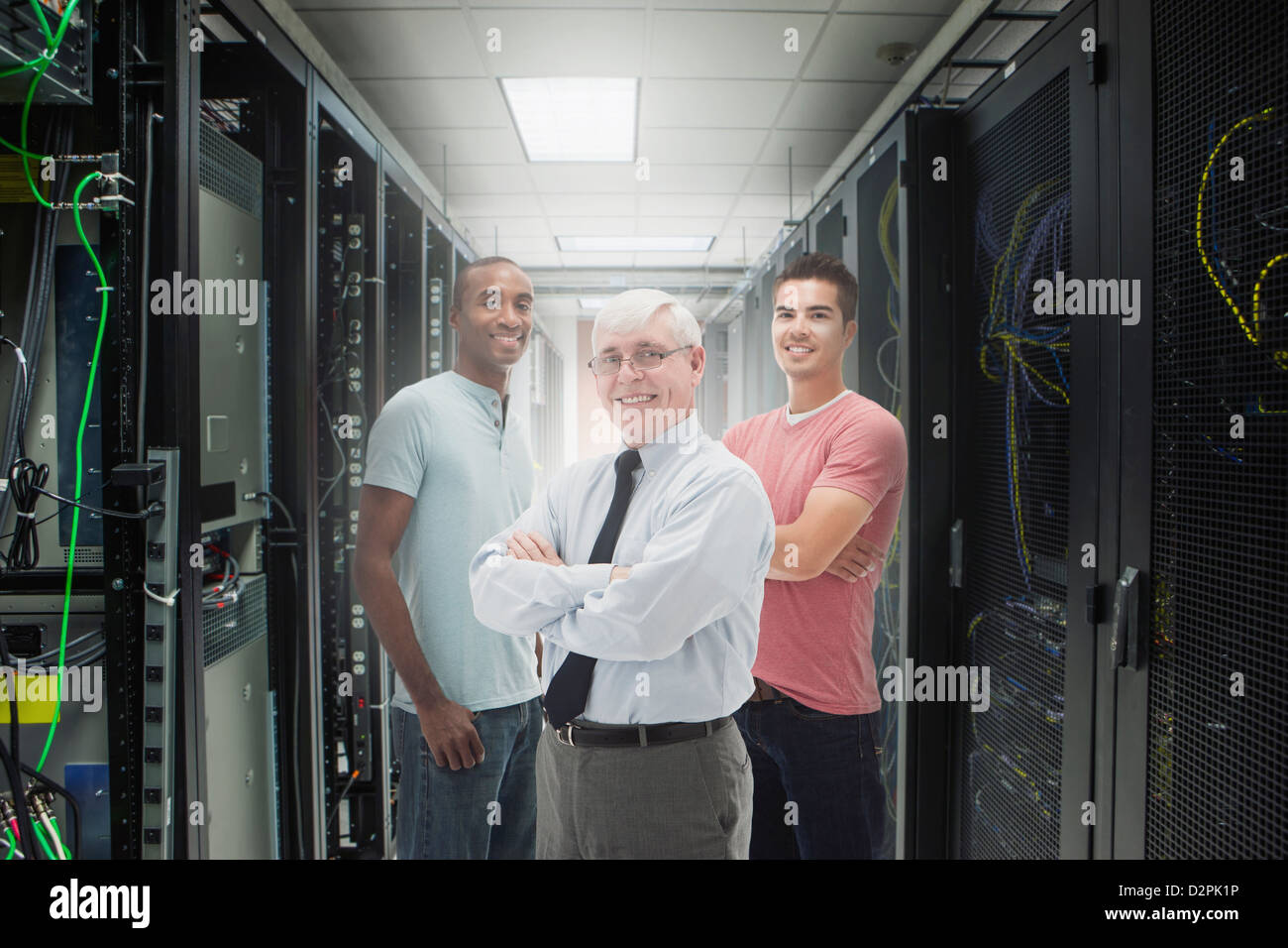 Businessmen standing in server room Stock Photo - Alamy