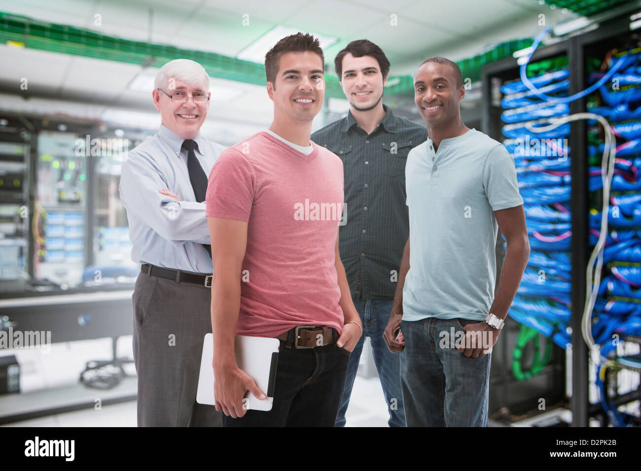 Businessmen standing in server room Stock Photo - Alamy