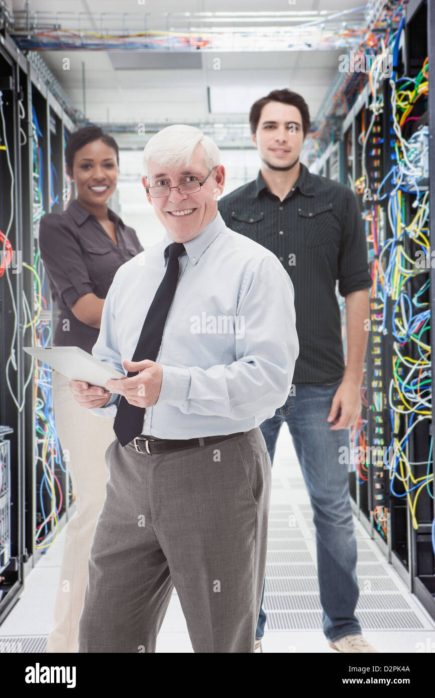 Business people standing in server room Stock Photo - Alamy