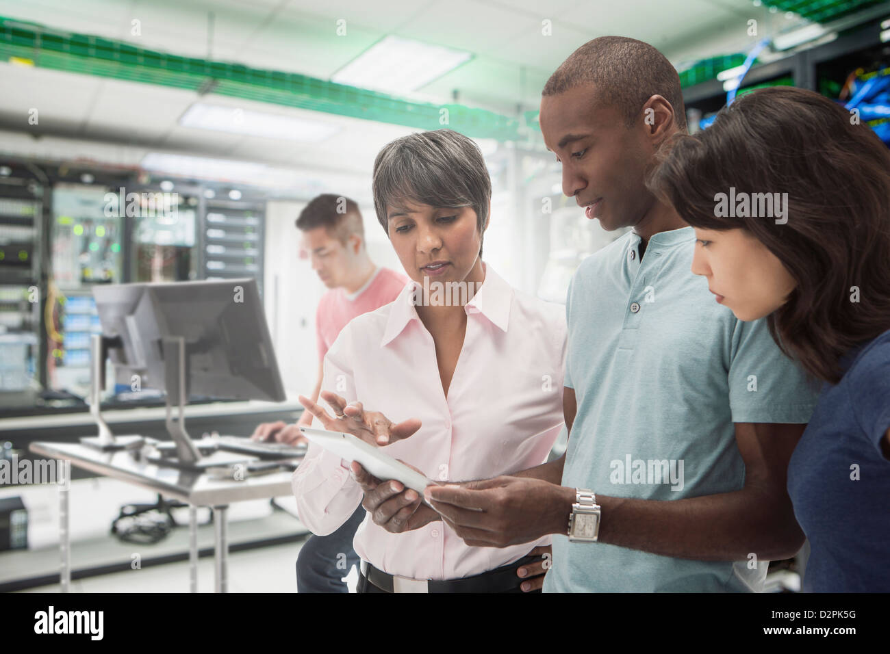 Business people working in server room Stock Photo - Alamy