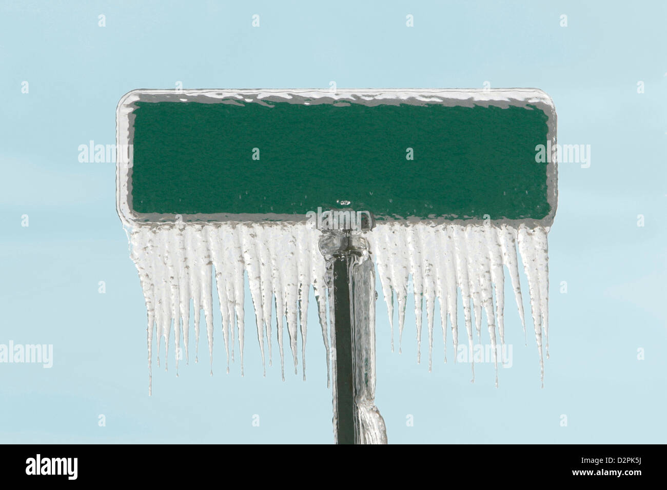 A blank street sign covered in ice. Green sign on a metal pole Stock ...
