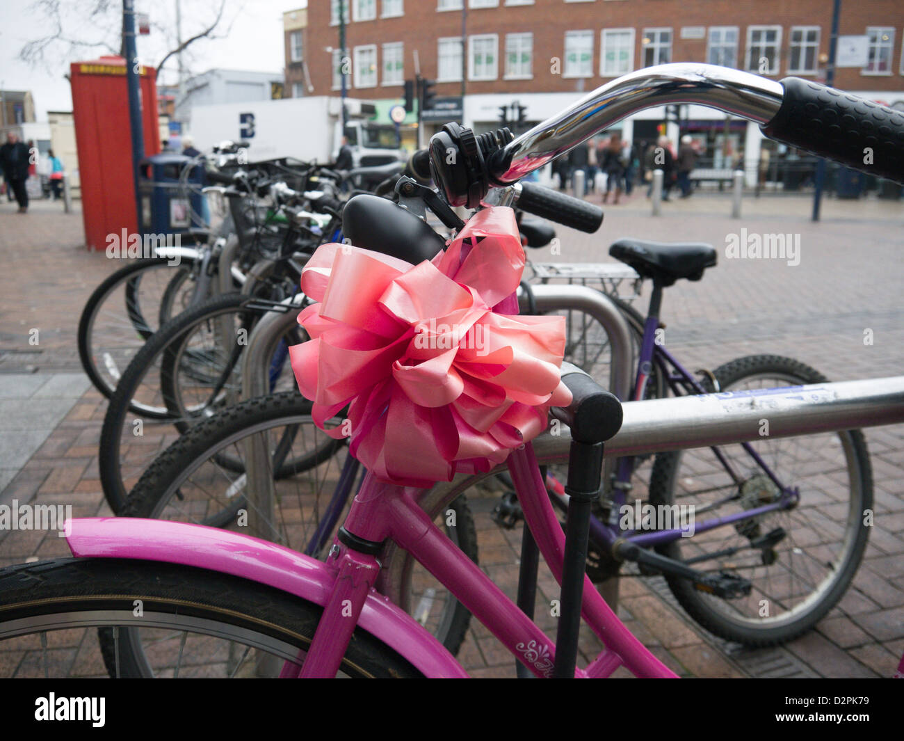 A ladies pink bicycle decorated with pink ribbon Stock Photo - Alamy