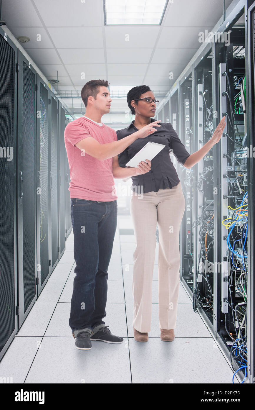 Business people working in server room Stock Photo - Alamy