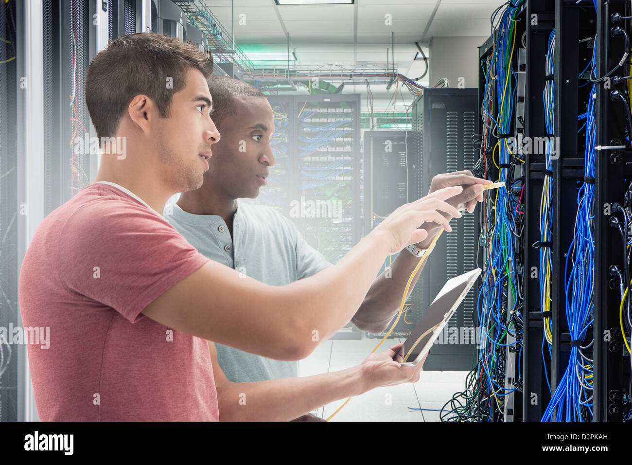 Businessmen working in server room Stock Photo - Alamy