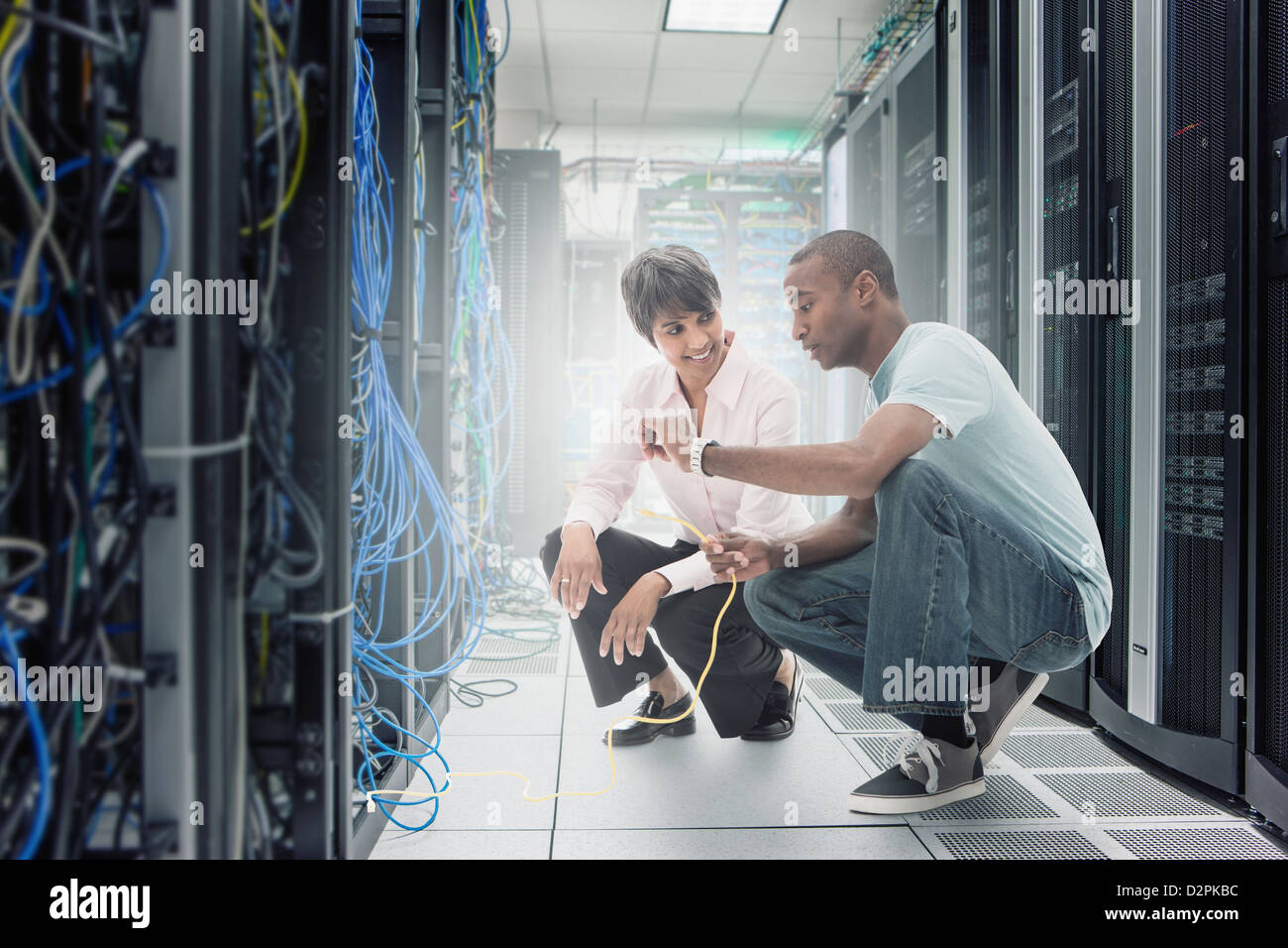 Business people working in server room Stock Photo - Alamy