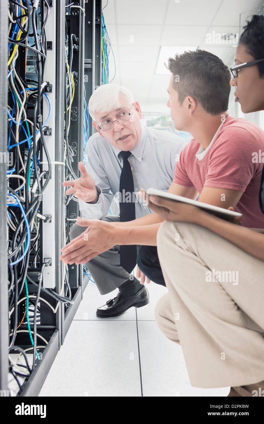 Business people working in server room Stock Photo - Alamy
