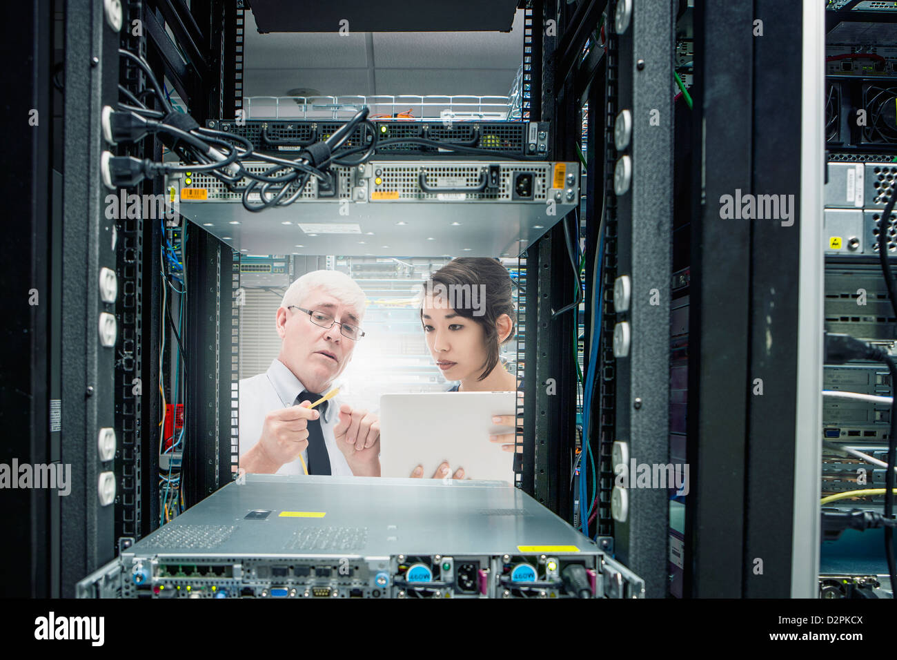 Business people working in server room Stock Photo - Alamy