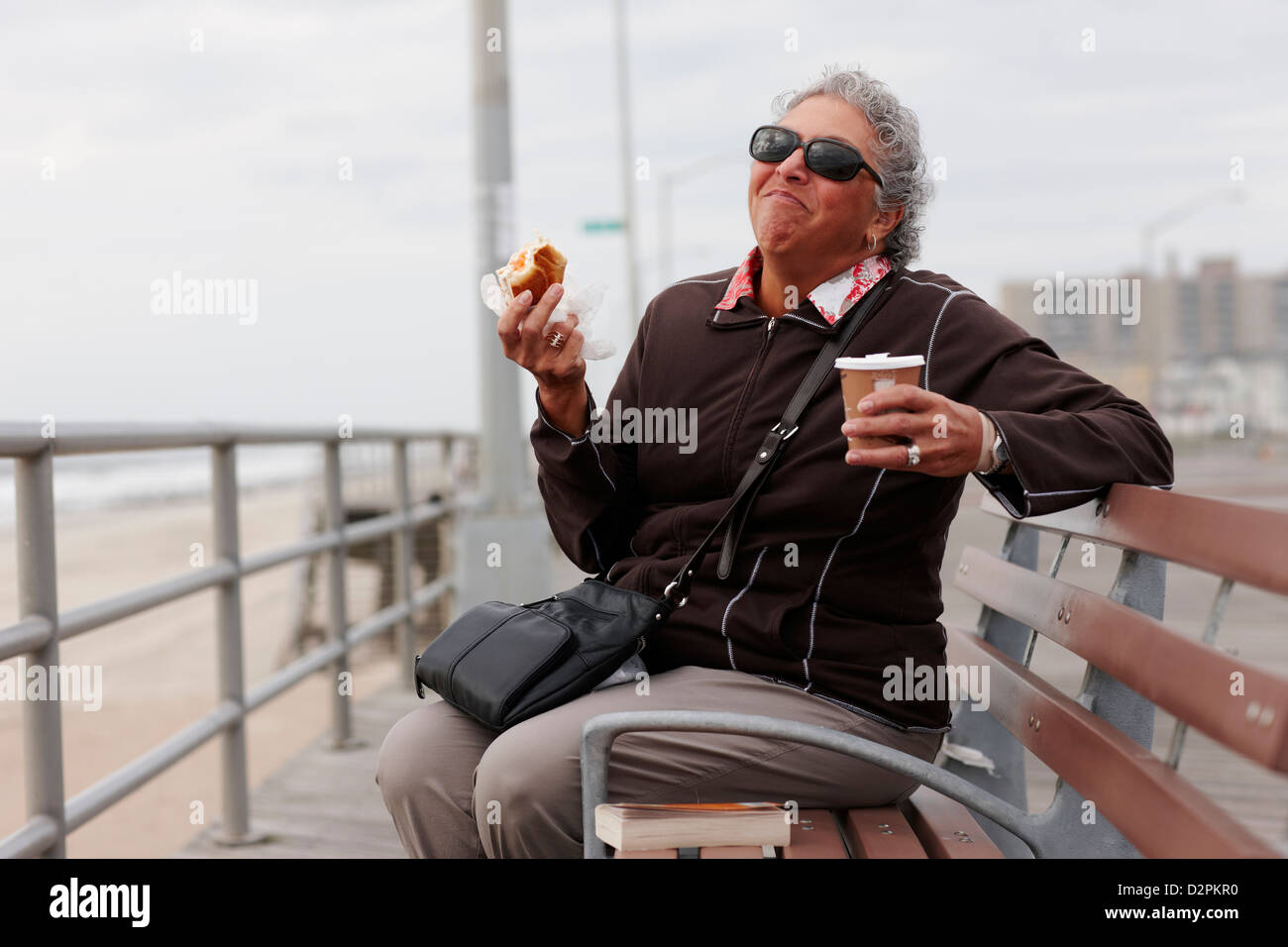 Women eating pastry and drinking coffee on boardwalk Stock Photo - Alamy