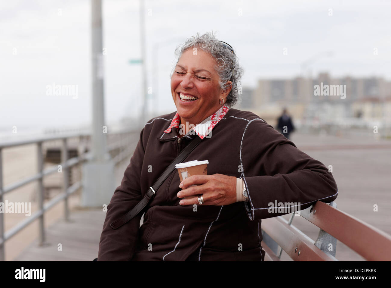 Woman sitting on boardwalk hi-res stock photography and images - Alamy