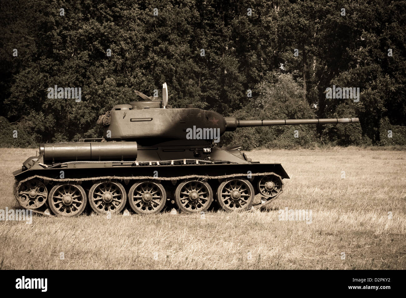 Damaged Soviet tank is covered in dark smoke - reenactment of World War ...