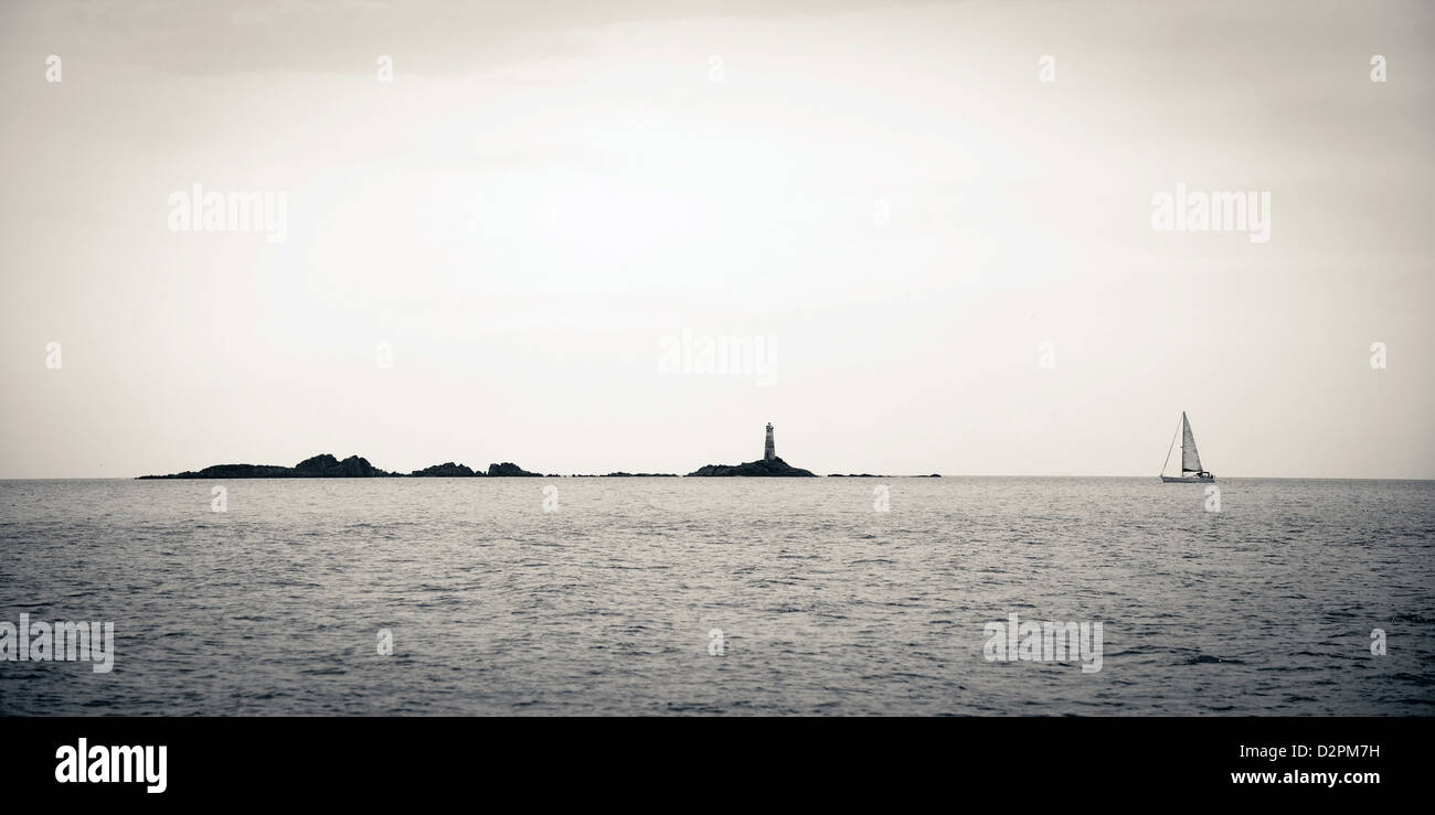 sepia tone picture of yacht sailing on the sea heading towards island ...