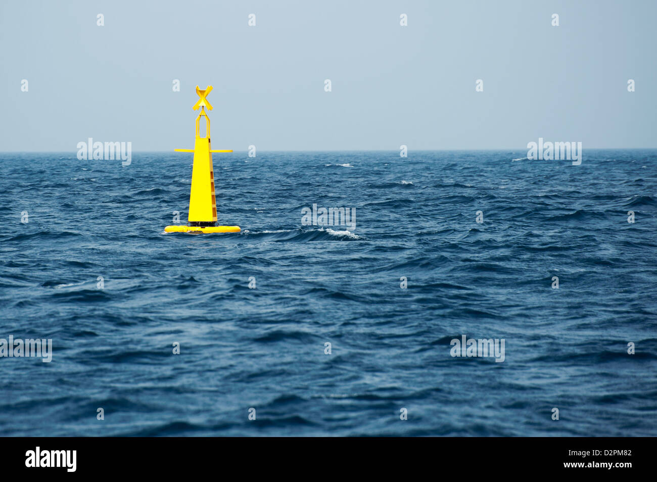 floating yellow buoy on blue sea Stock Photo - Alamy