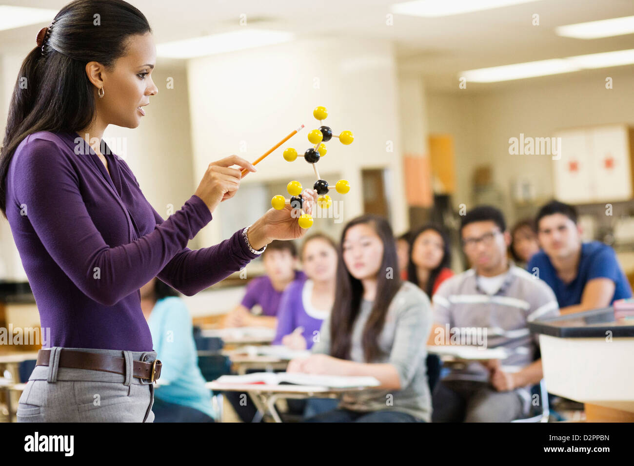 Teacher explaining chemistry model to classroom Stock Photo - Alamy