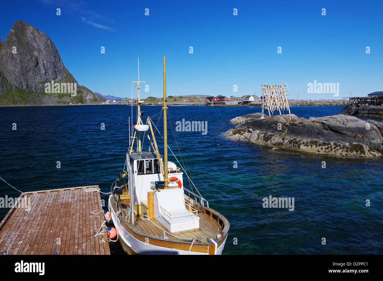 Traditional fishing boat in scenic harbor on Lofoten islands in Norway ...