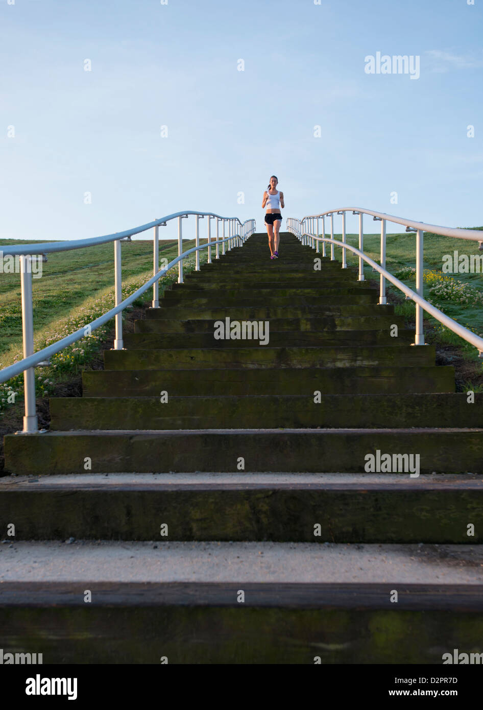 Caucasian woman running up steps Stock Photo - Alamy