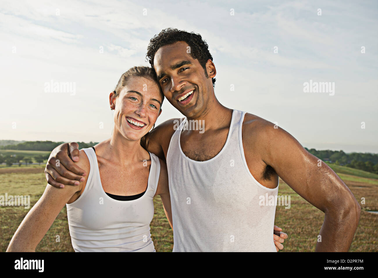Couple hugging in field Stock Photo - Alamy