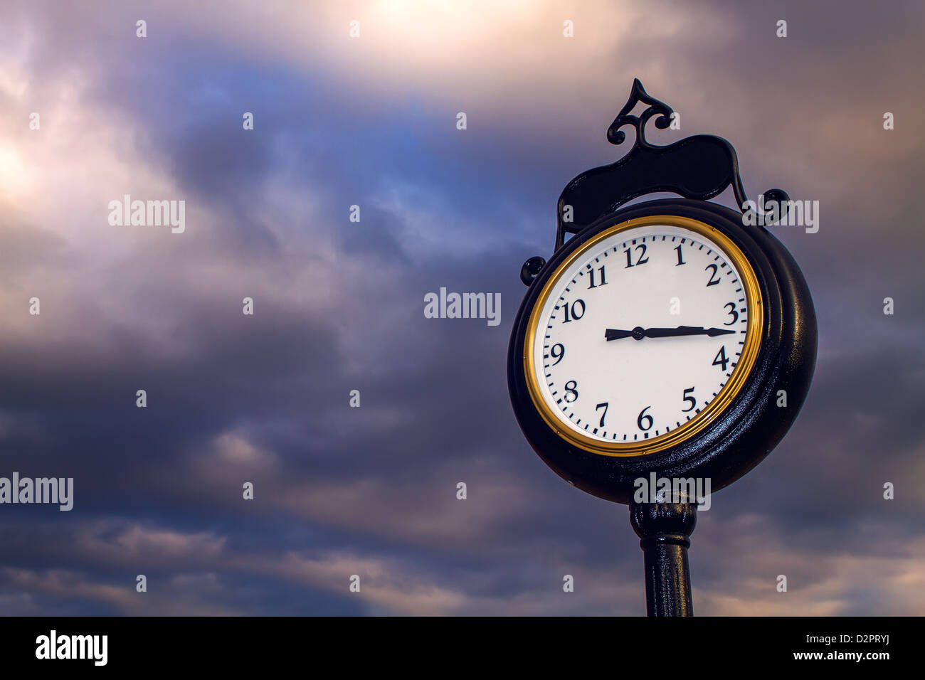 A vintage looking clock against a cloudy sky Stock Photo - Alamy