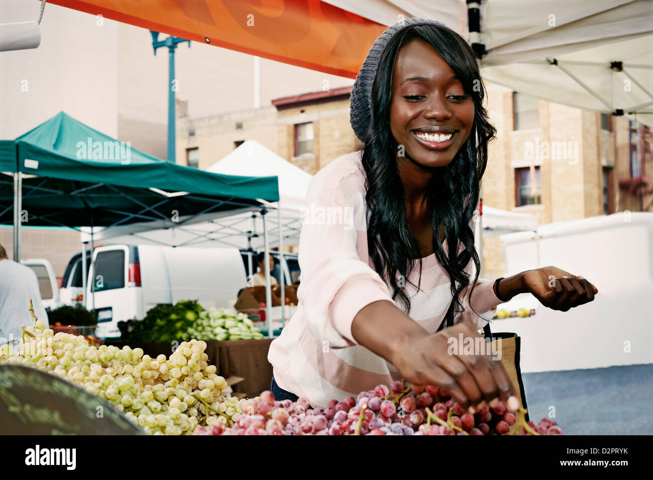 African American woman buying grapes Stock Photo - Alamy
