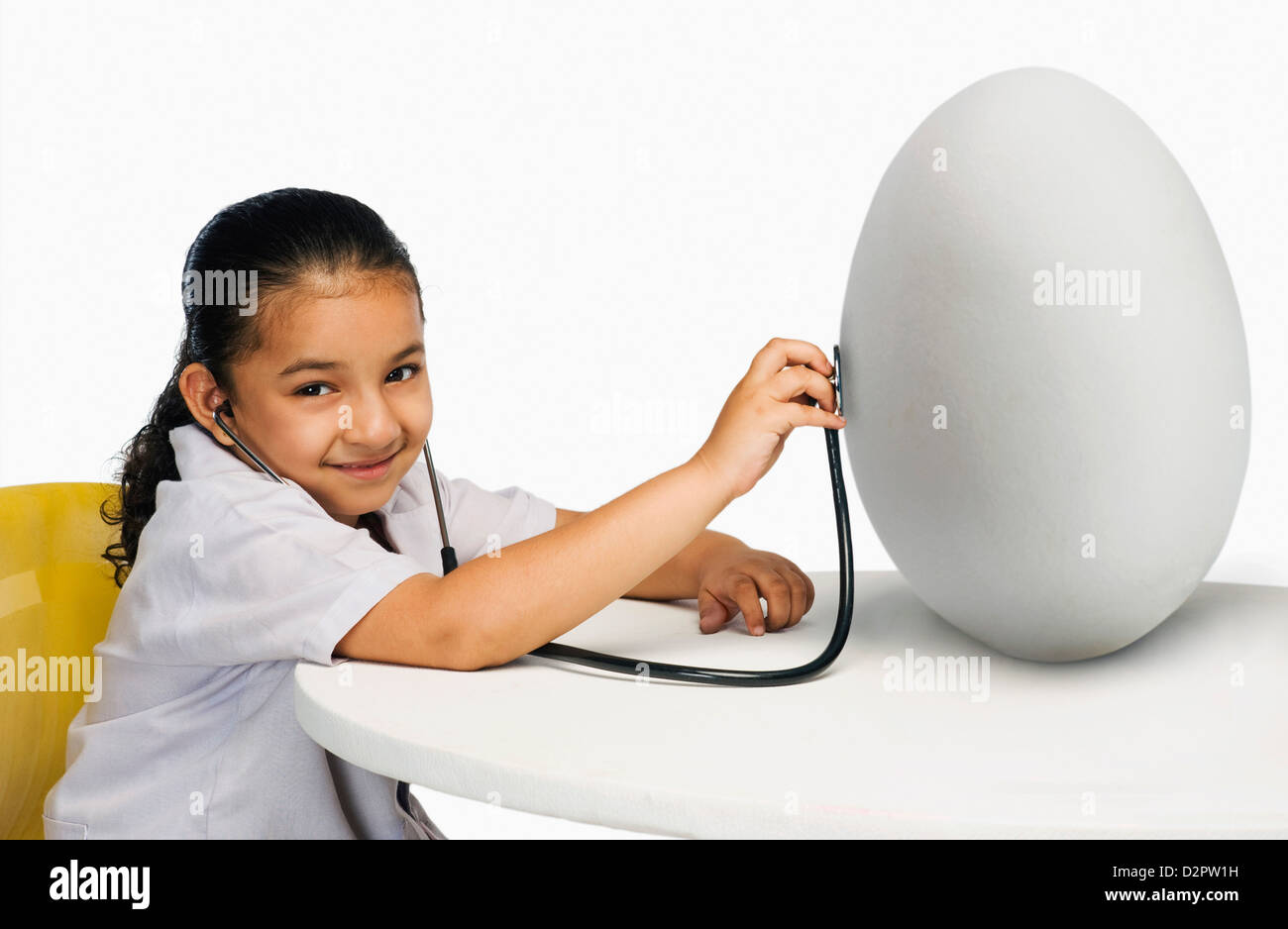 Girl examining a egg with a stethoscope Stock Photo - Alamy